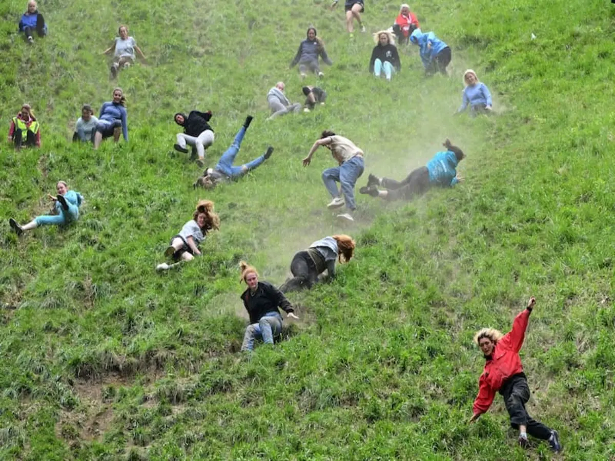 Watch: Competitors risk life after a rolling wheel of cheese in UK's ...