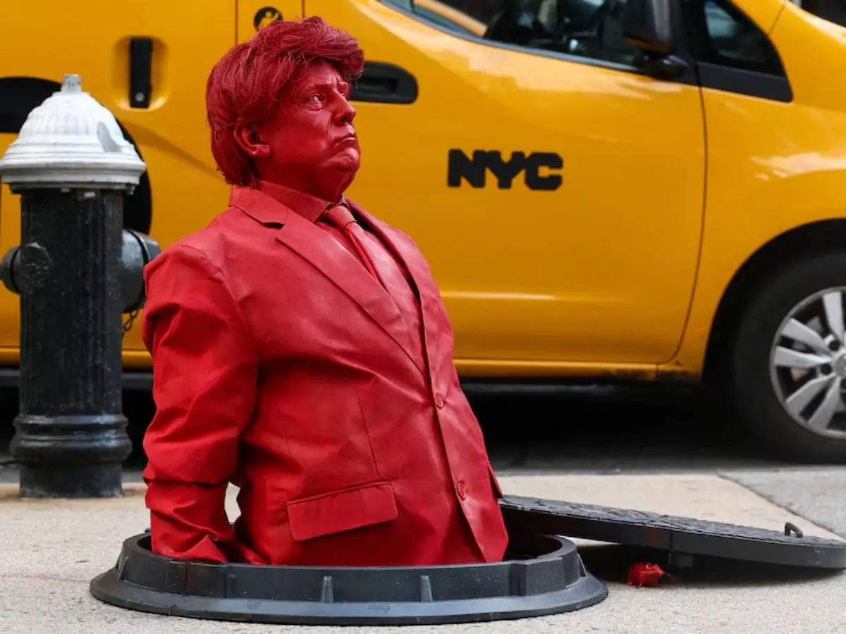 Bright red Trump sculpture appears from a manhole in Manhattan - White ...
